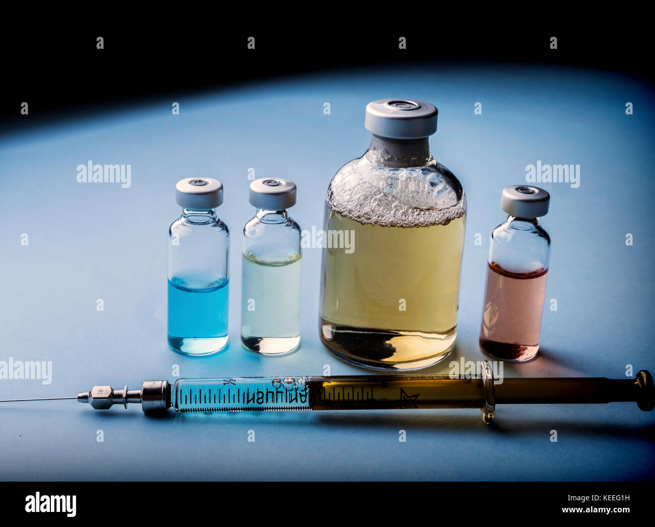 Several vials and syringe in laboratory, conceptual image Stock Photo - Alamy