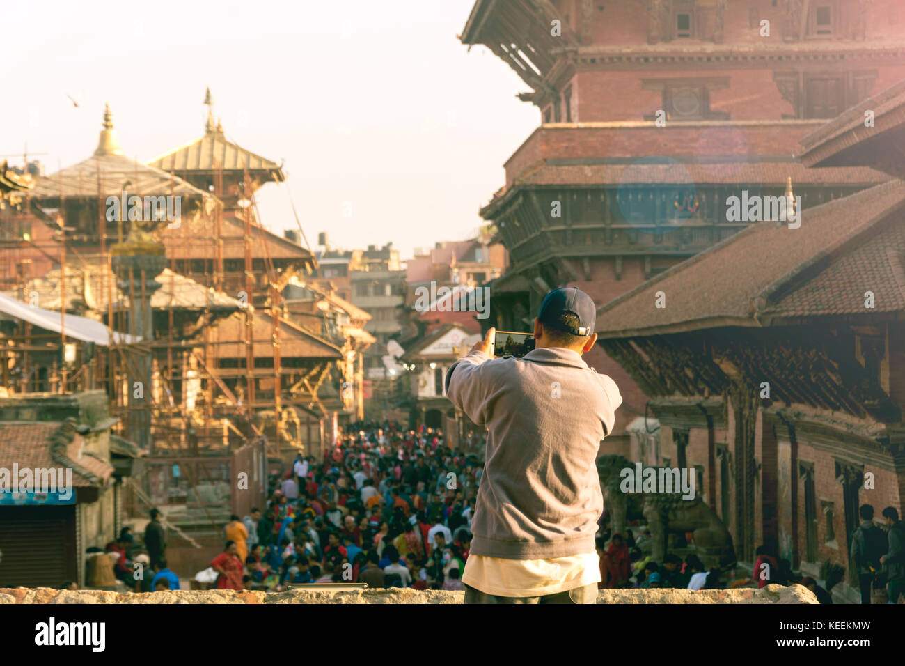 unknown guy taking picture of crowd at Patan Durbar Square by his smart ...