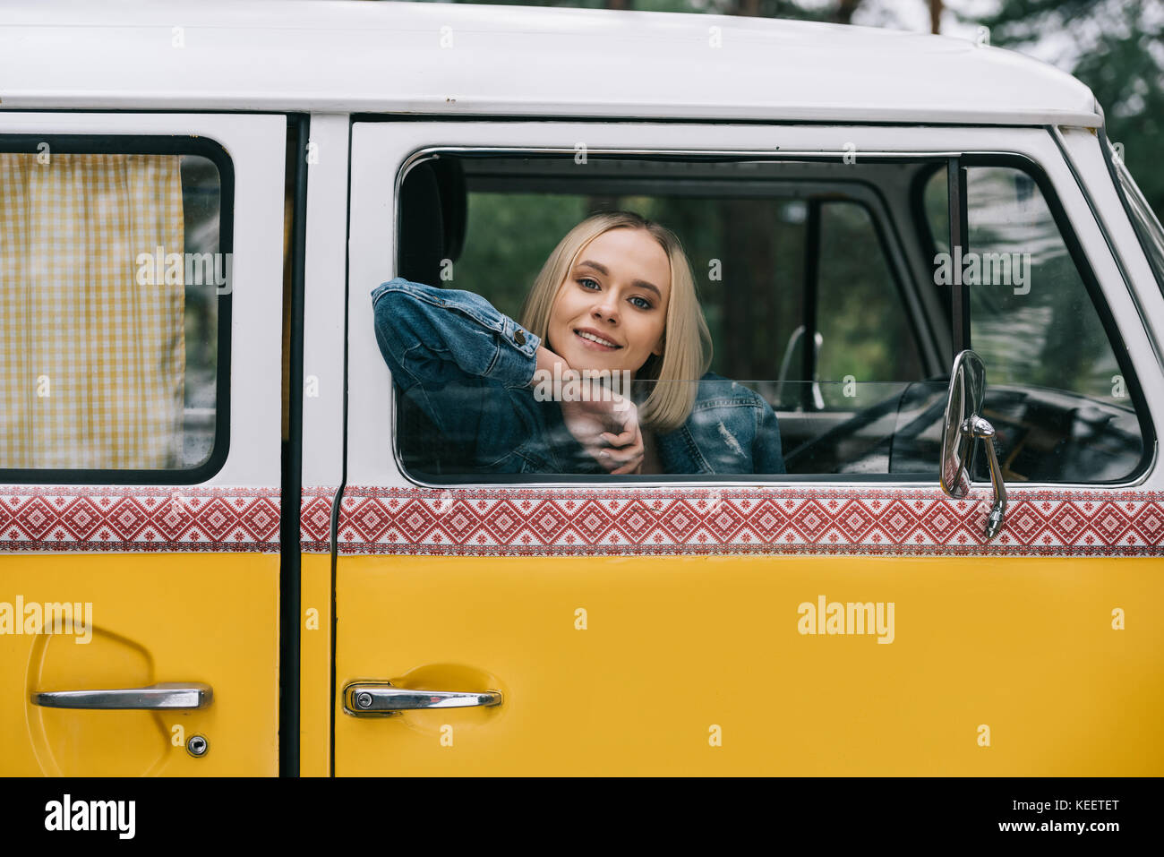 attractive blonde girl sitting in retro styled minivan Stock Photo - Alamy