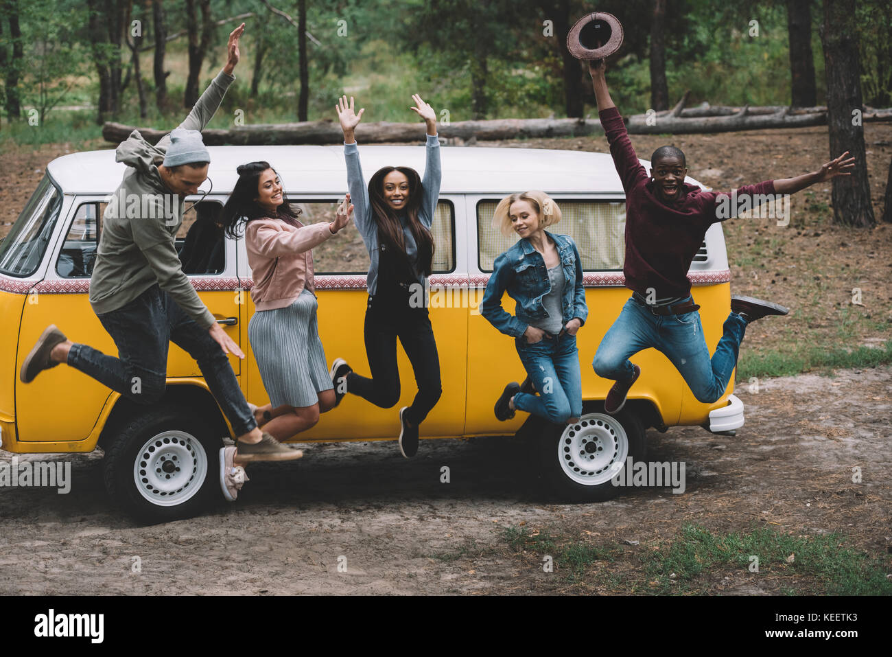 young multiethnic friends jumping and having fun together at retro ...