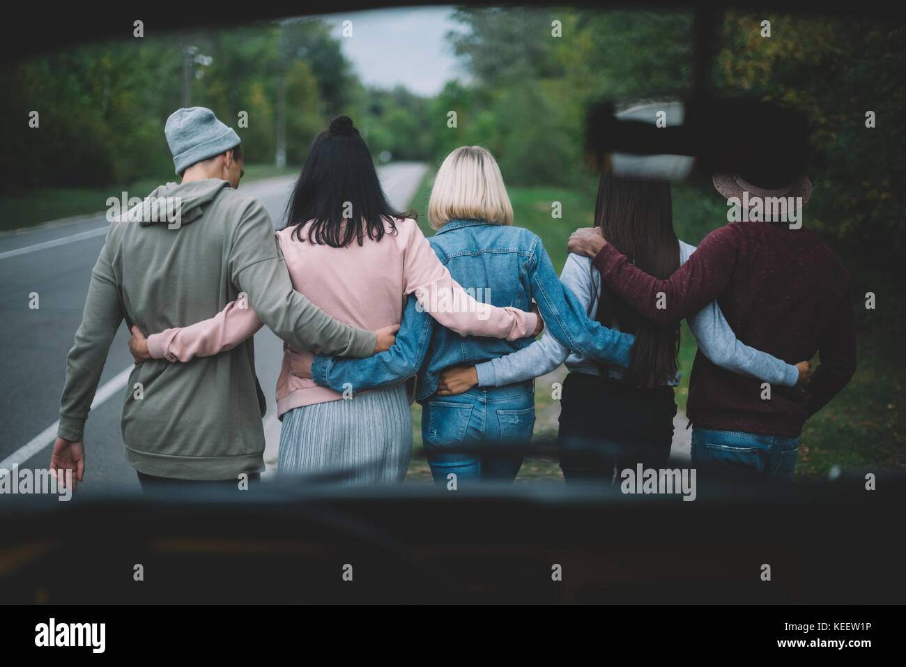 back view of friends hugging and walking together Stock Photo - Alamy