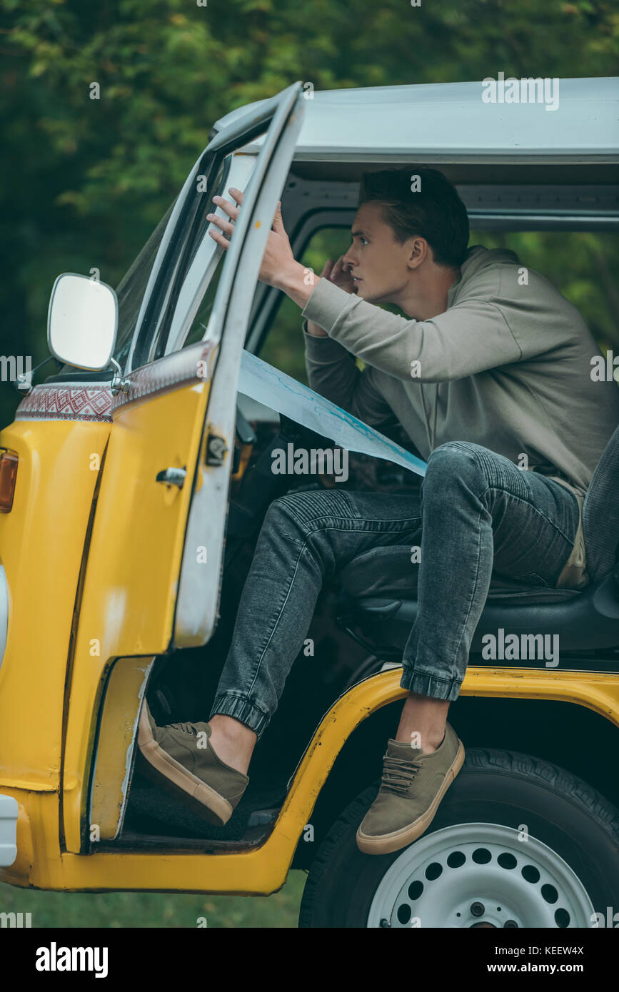 handsome young man sitting in retro minivan Stock Photo - Alamy