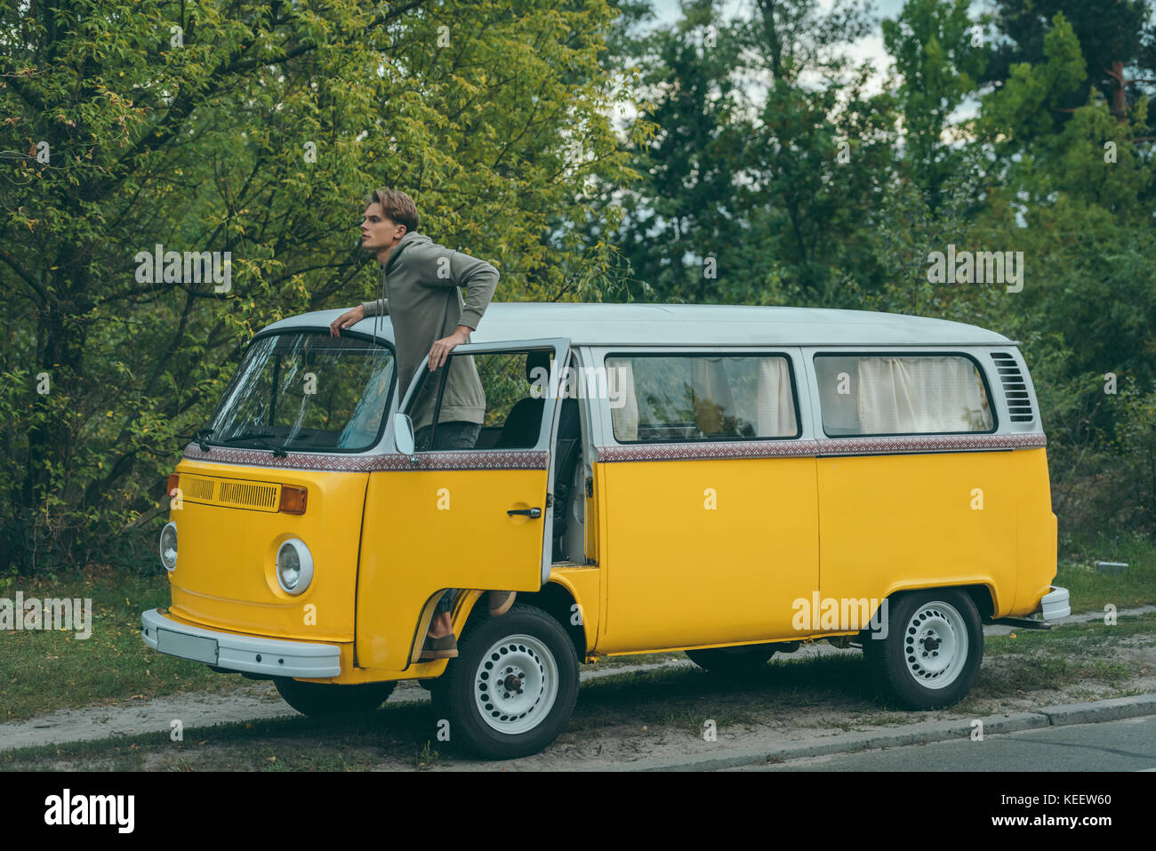 handsome young traveler in retro minivan looking away Stock Photo - Alamy
