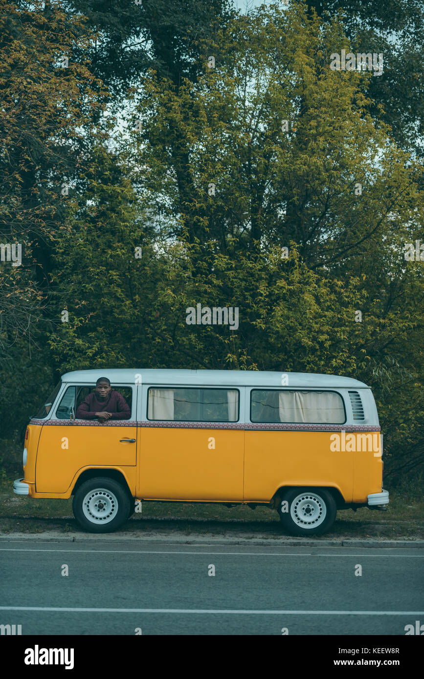handsome young african american man sitting in retro minivan Stock ...