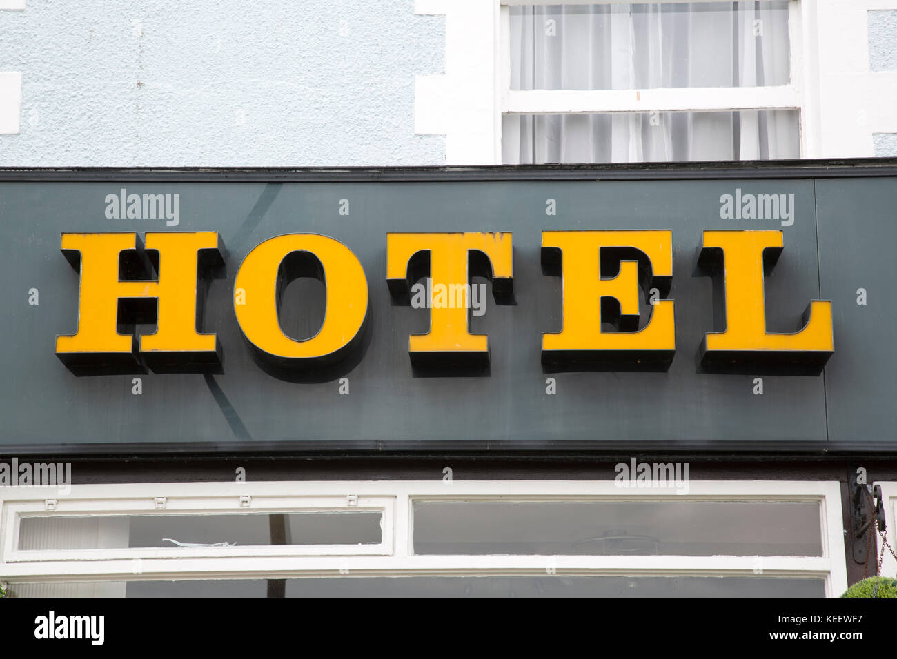 Yellow Hotel Sign on Building Facade Stock Photo - Alamy