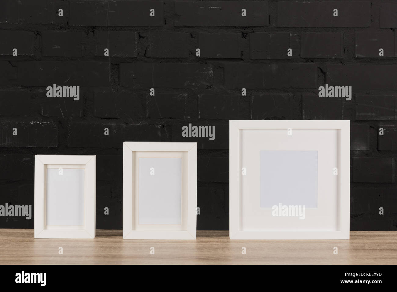 close up view of empty photo frames on wooden tabletop Stock Photo - Alamy