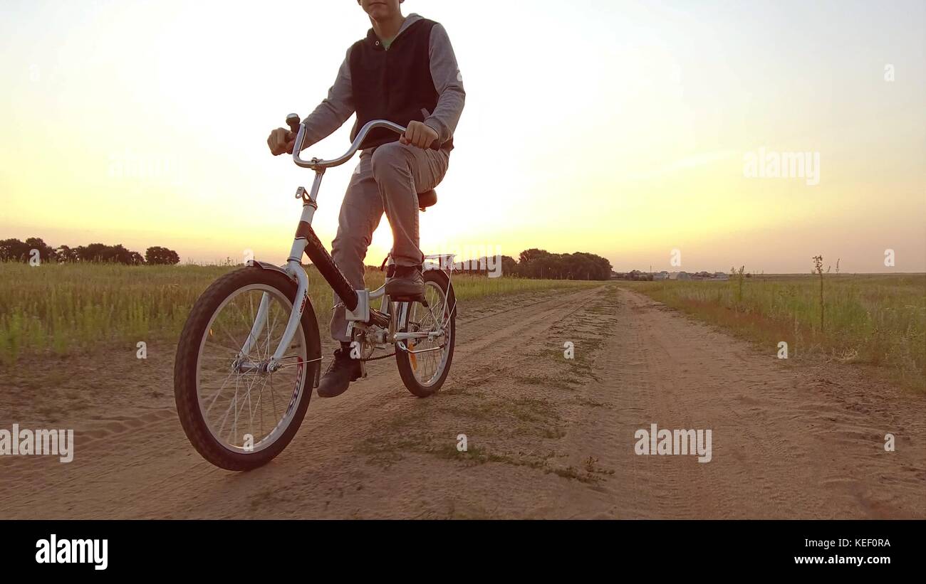 Boy teenager riding a bicycle. Boy teenager riding a bicycle goes to ...
