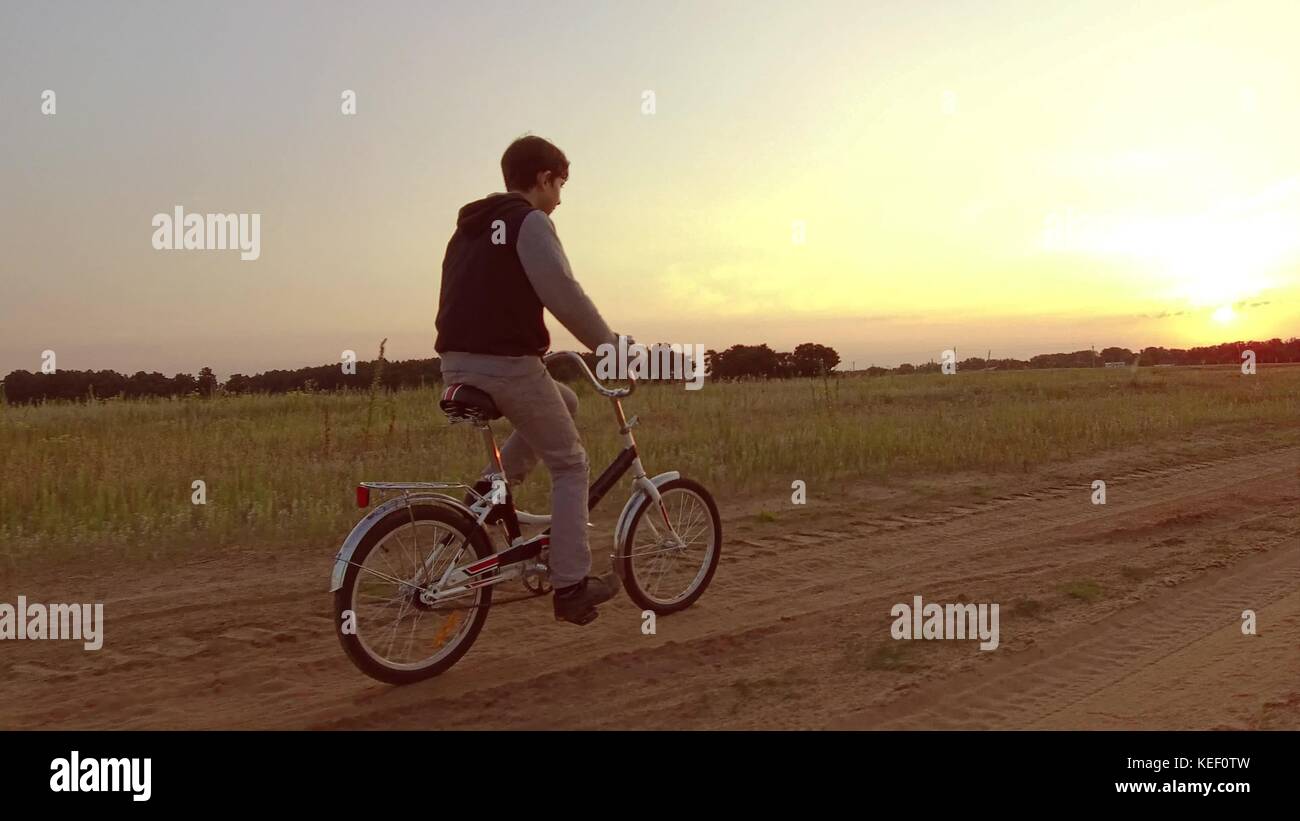 Boy teenager riding a bicycle. Boy teenager riding a bicycle goes to ...