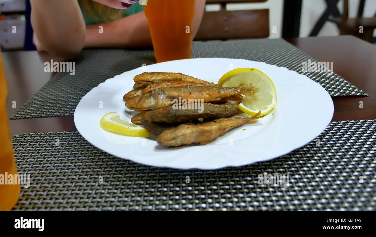 Fried surmullet fish on a plate with lemon. Delicious dinner Stock ...
