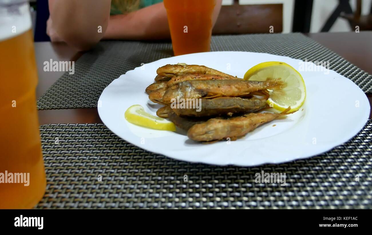 Fried surmullet fish on a plate with lemon. Delicious dinner Stock ...