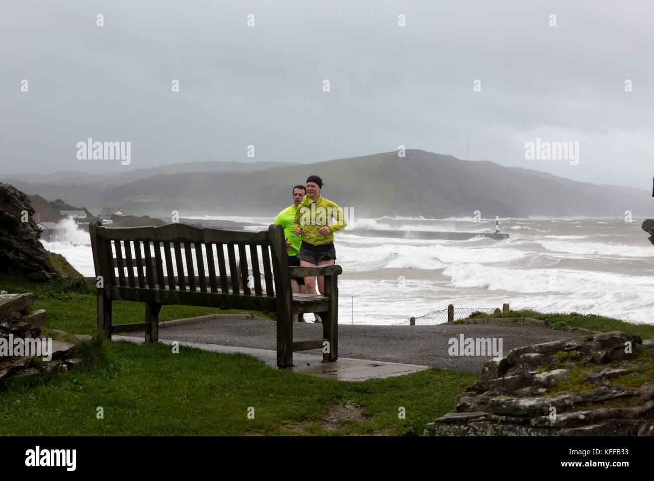 Man and woman jogging in bad weather. Credit: Ian Jones/Alamy Live News ...