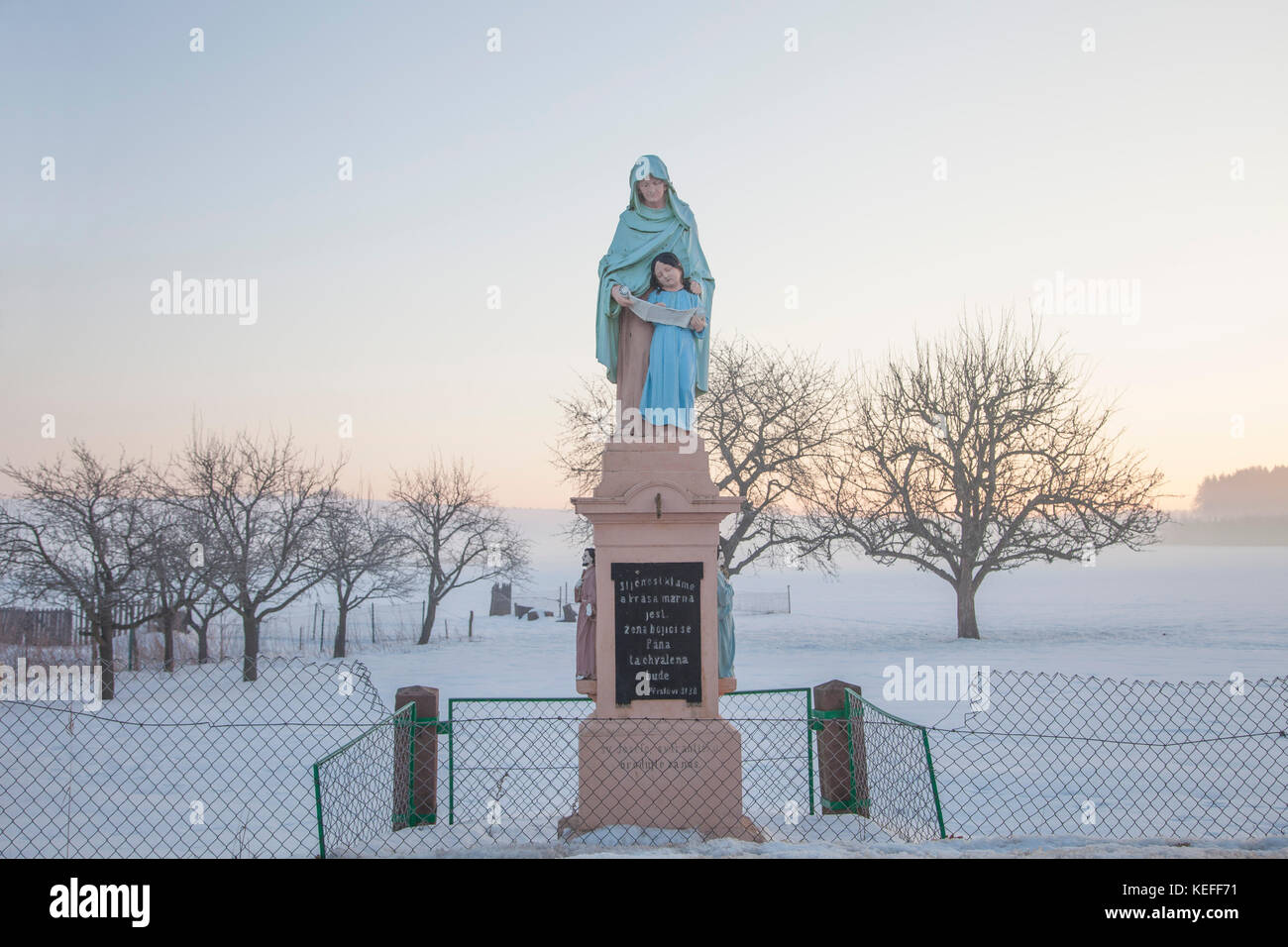 Statue of the saint over the trees in winter Stock Photo - Alamy