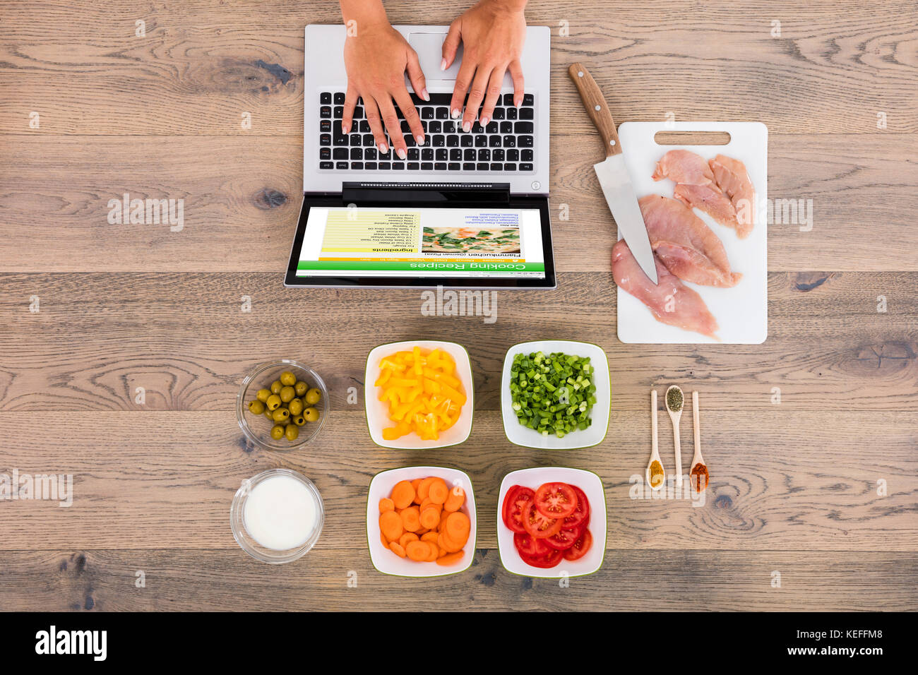 High Angle View Of Person Looking For The Recipe Online Using Laptop In ...