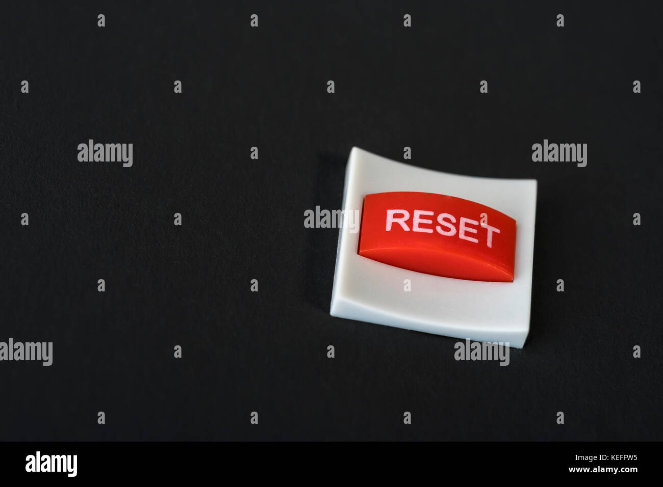 Macro-photo of small red Reset button - visual metaphor for staring ...
