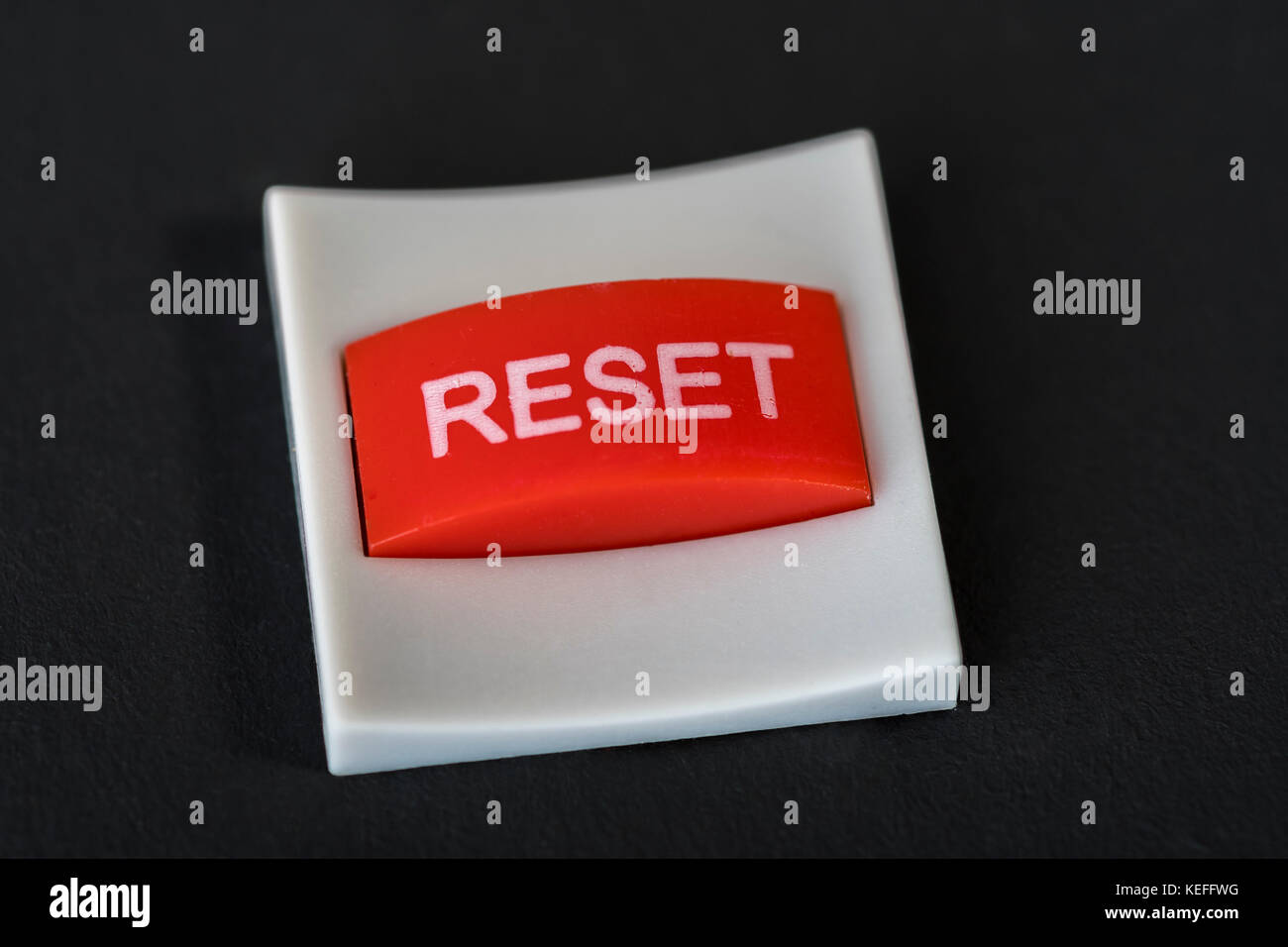 Macro-photo of small red Reset button - visual metaphor for staring ...