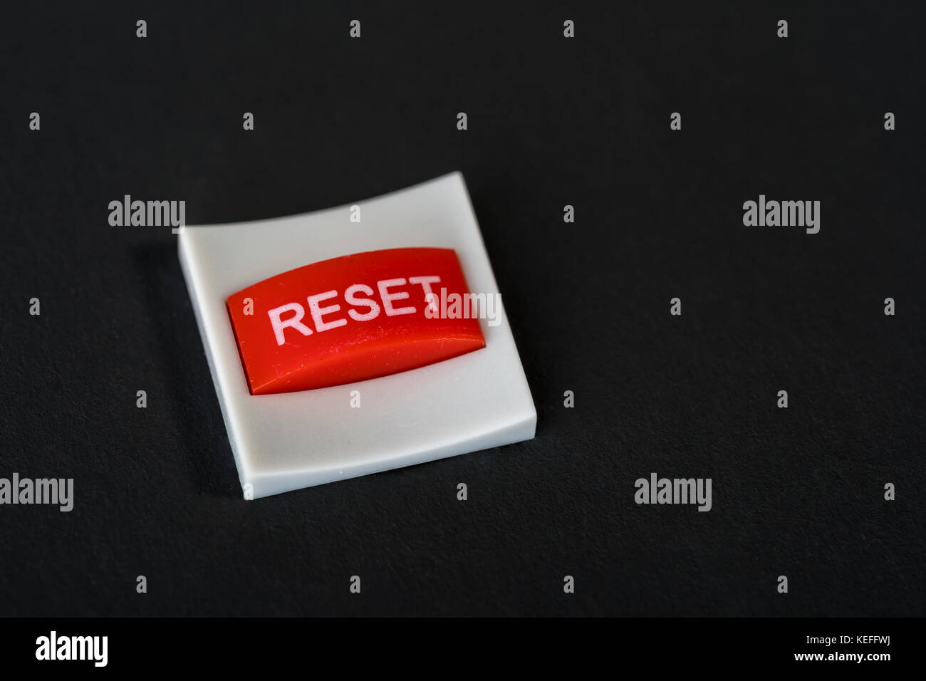 Macro-photo of small red Reset button - visual metaphor for staring ...