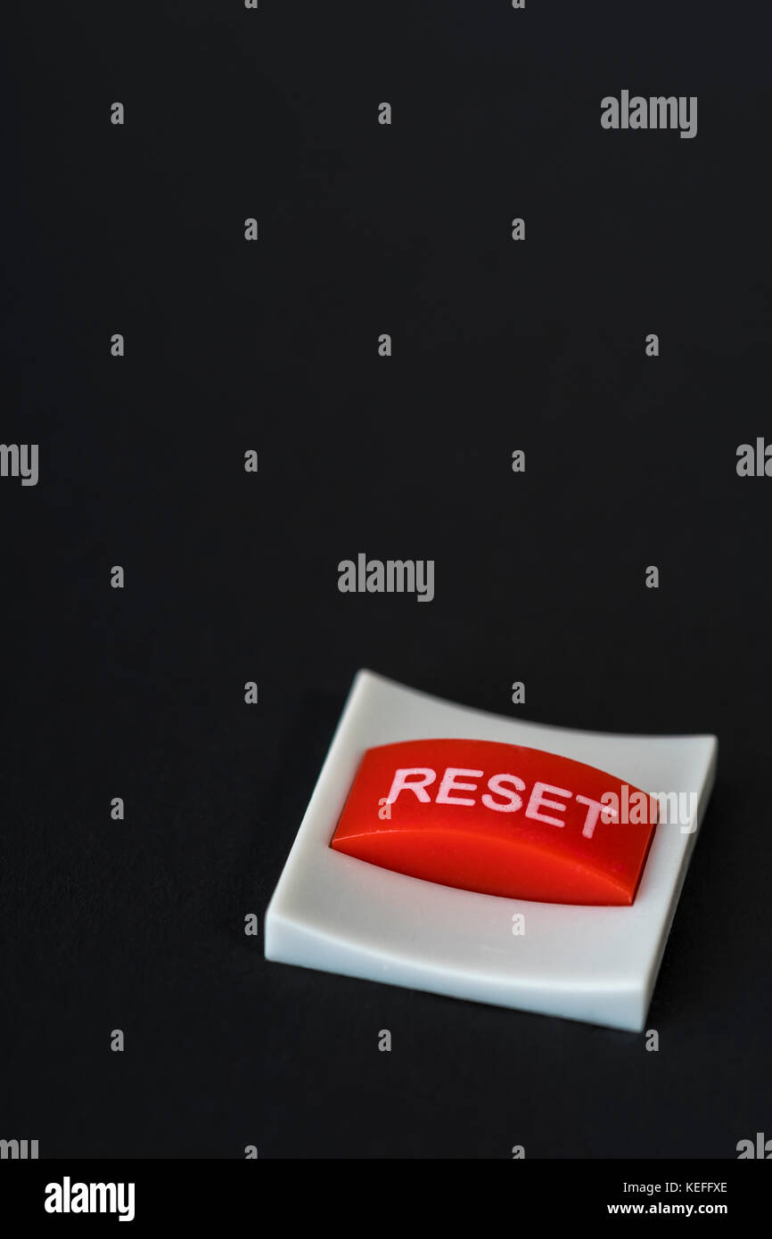 Macro-photo of small red Reset button - visual metaphor for staring ...
