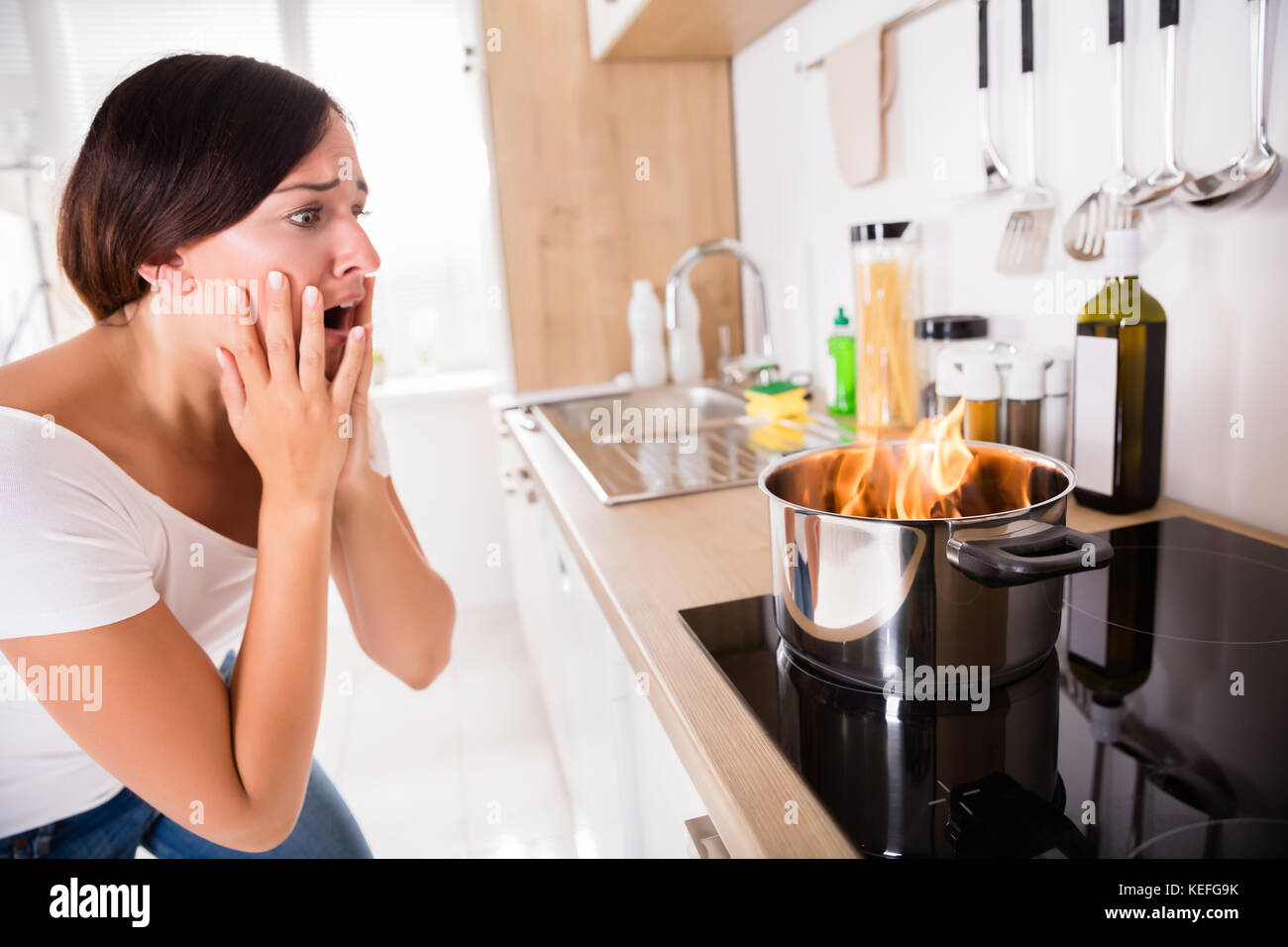 Shocked Young Woman Looking At Burnt Food In Cooking Pot Stock Photo ...