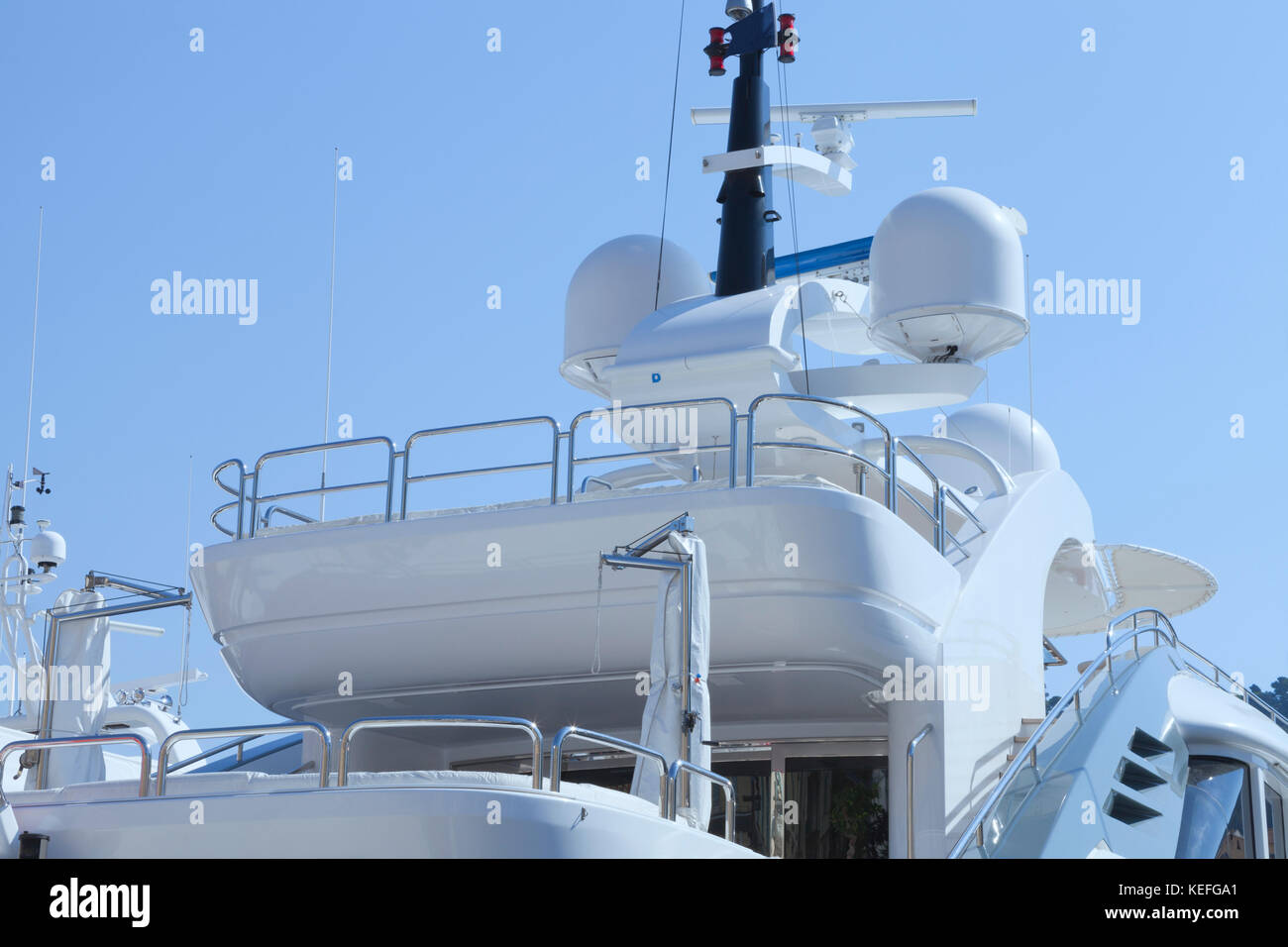 Front of a modern luxury yacht deck with navigation radar against blue ...
