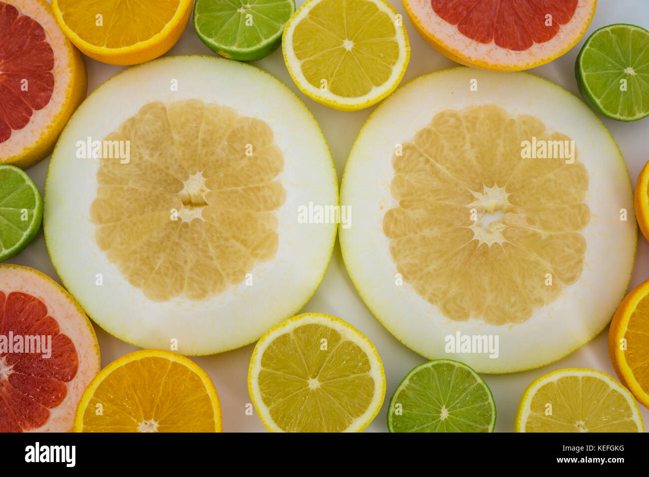 Slices of various citrus fruits on white background Stock Photo - Alamy