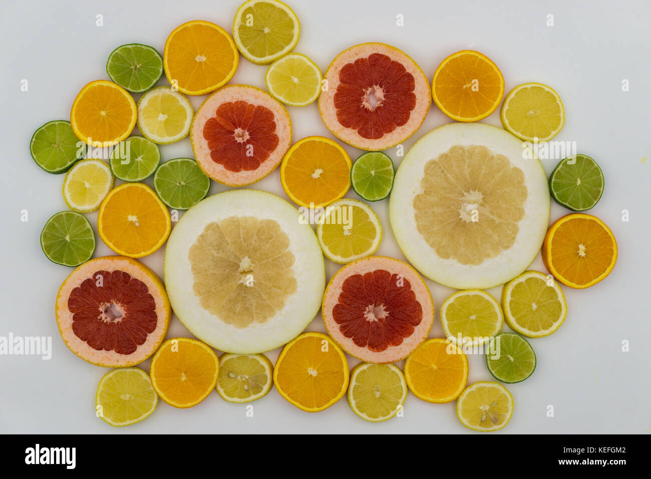 Slices of various citrus fruits on white background Stock Photo - Alamy