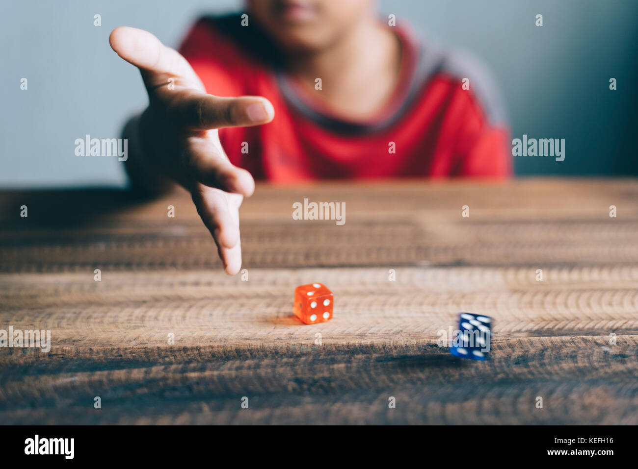 Child rolling dice hi-res stock photography and images - Alamy