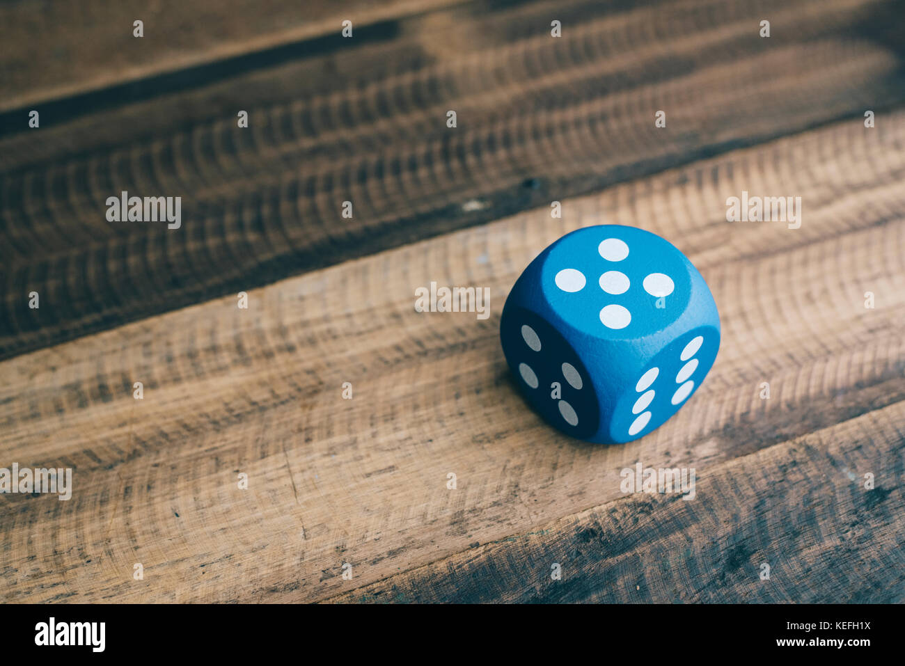 dice on a wooden table background Stock Photo - Alamy