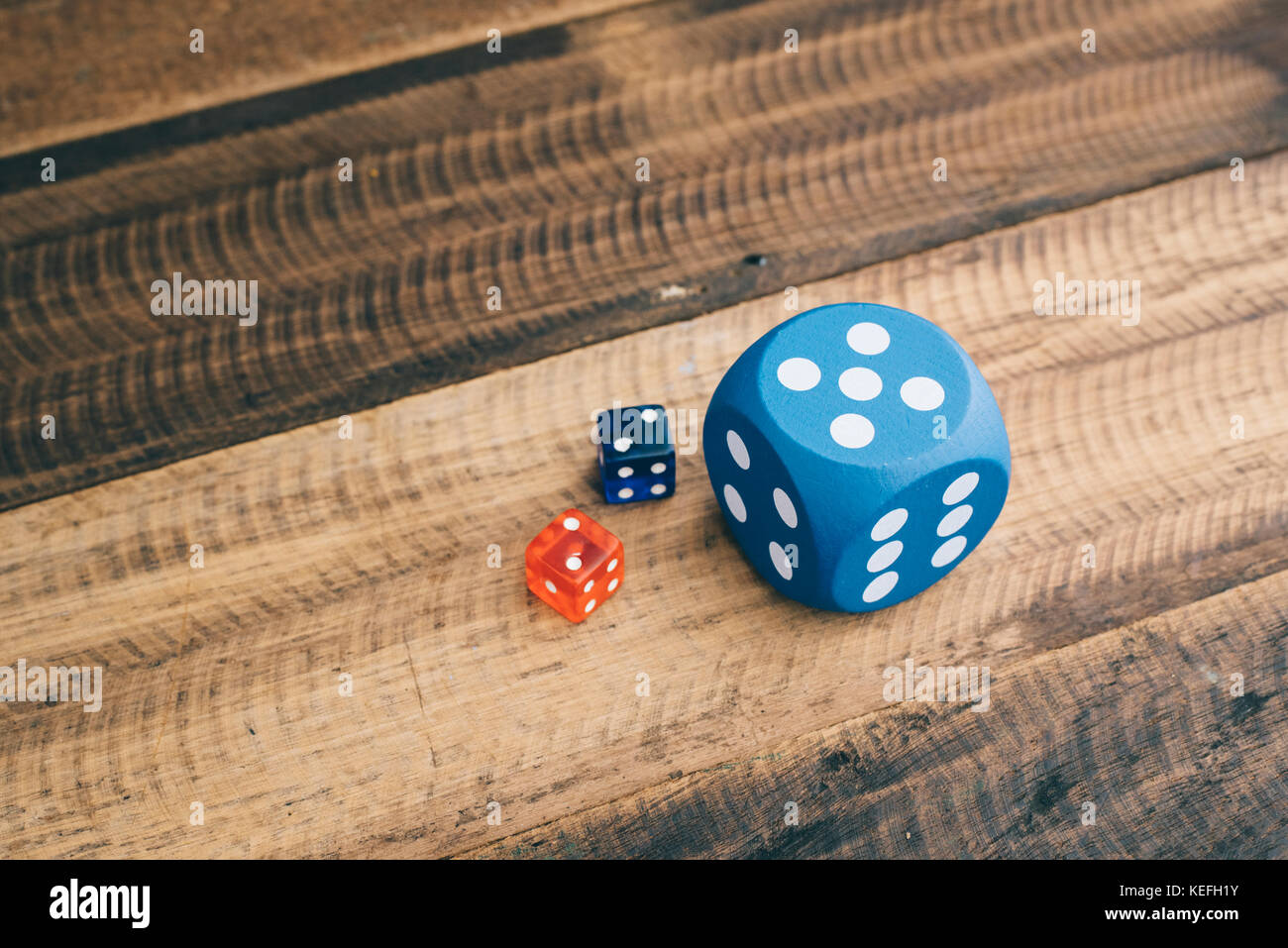 dice on a wooden table background Stock Photo - Alamy