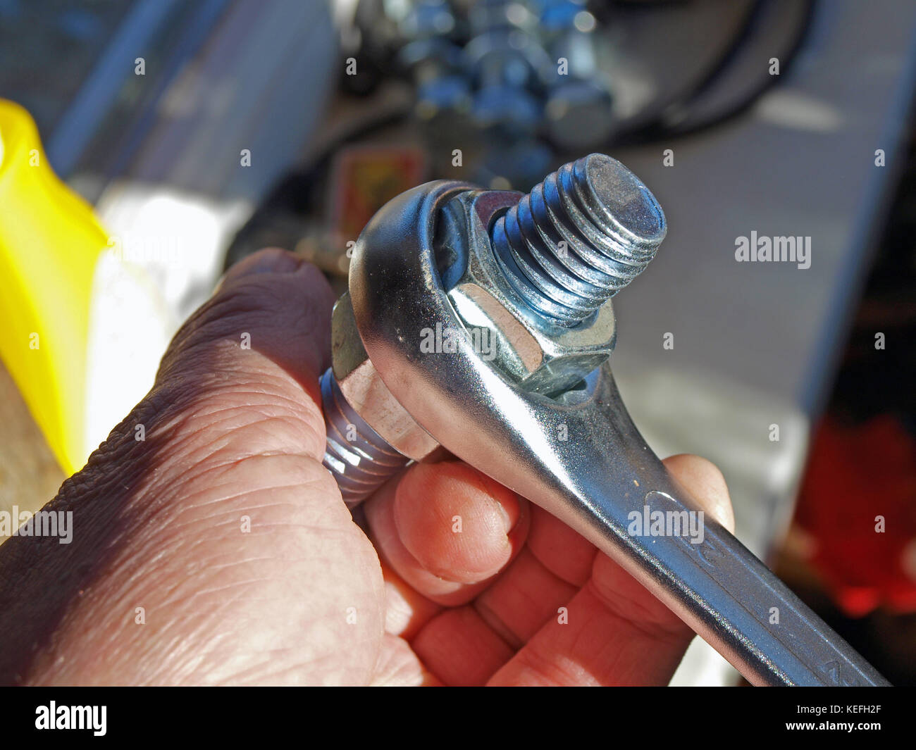 Bolt with nuts and wrench, close up Stock Photo - Alamy