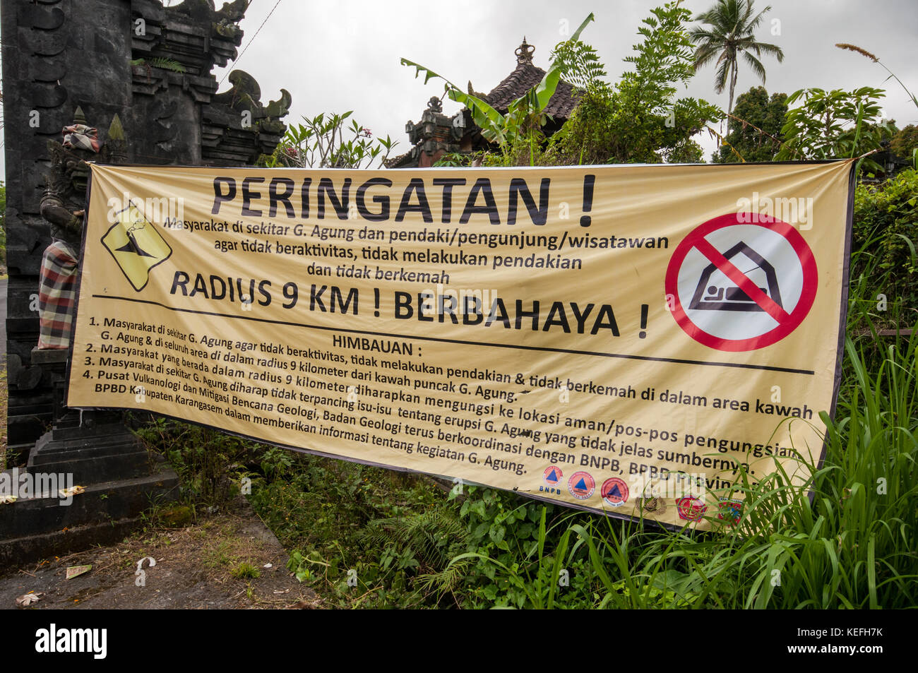 Warning sign in dangerous zone near the volcanic mountain Agung on Bali ...