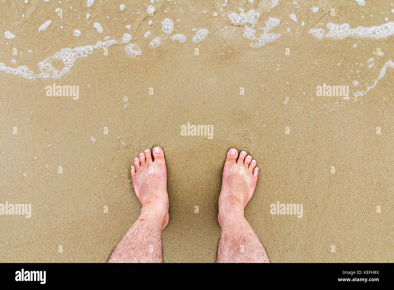 Top down view of feet on the beach with copy space Stock Photo - Alamy