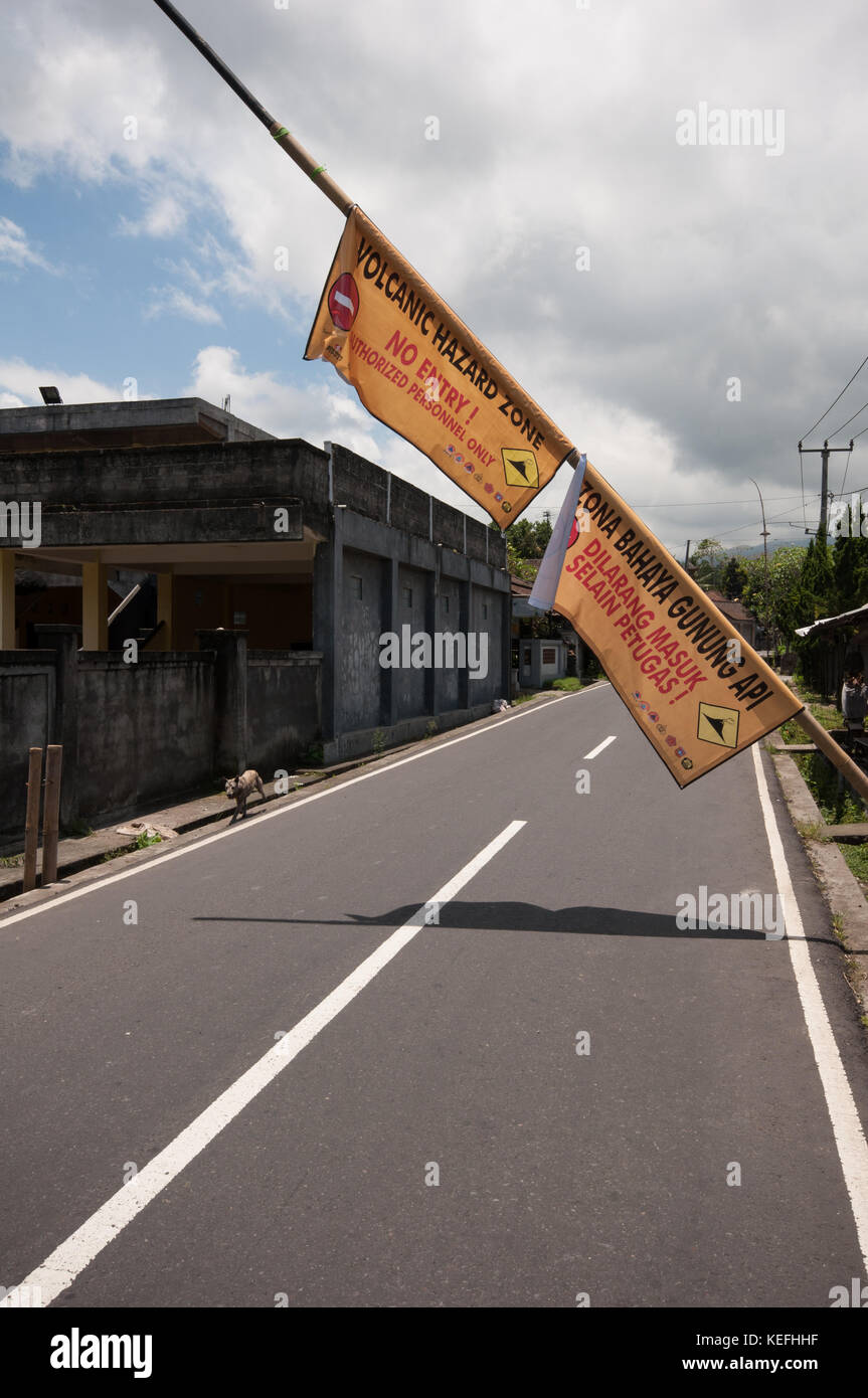 Warning sign in dangerous zone near the volcanic mountain Agung on Bali ...