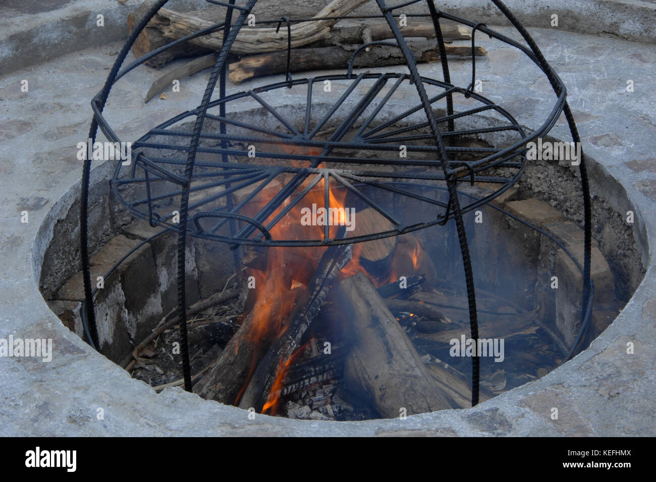 in the pit a construction of metal rods for smoke. metal structure for ...