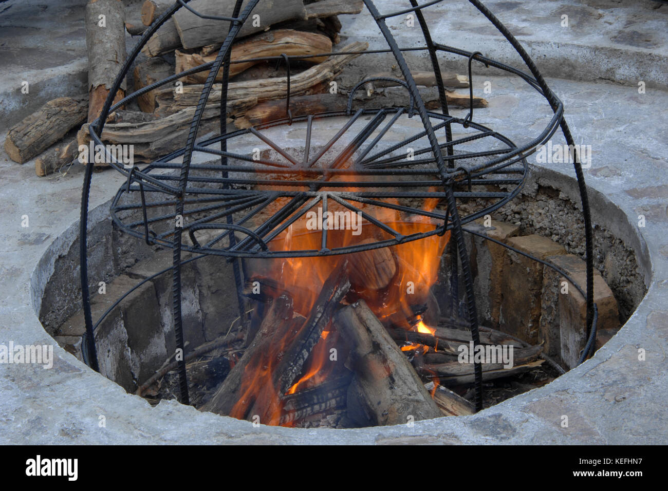 in the pit a construction of metal rods for smoke. metal structure for ...