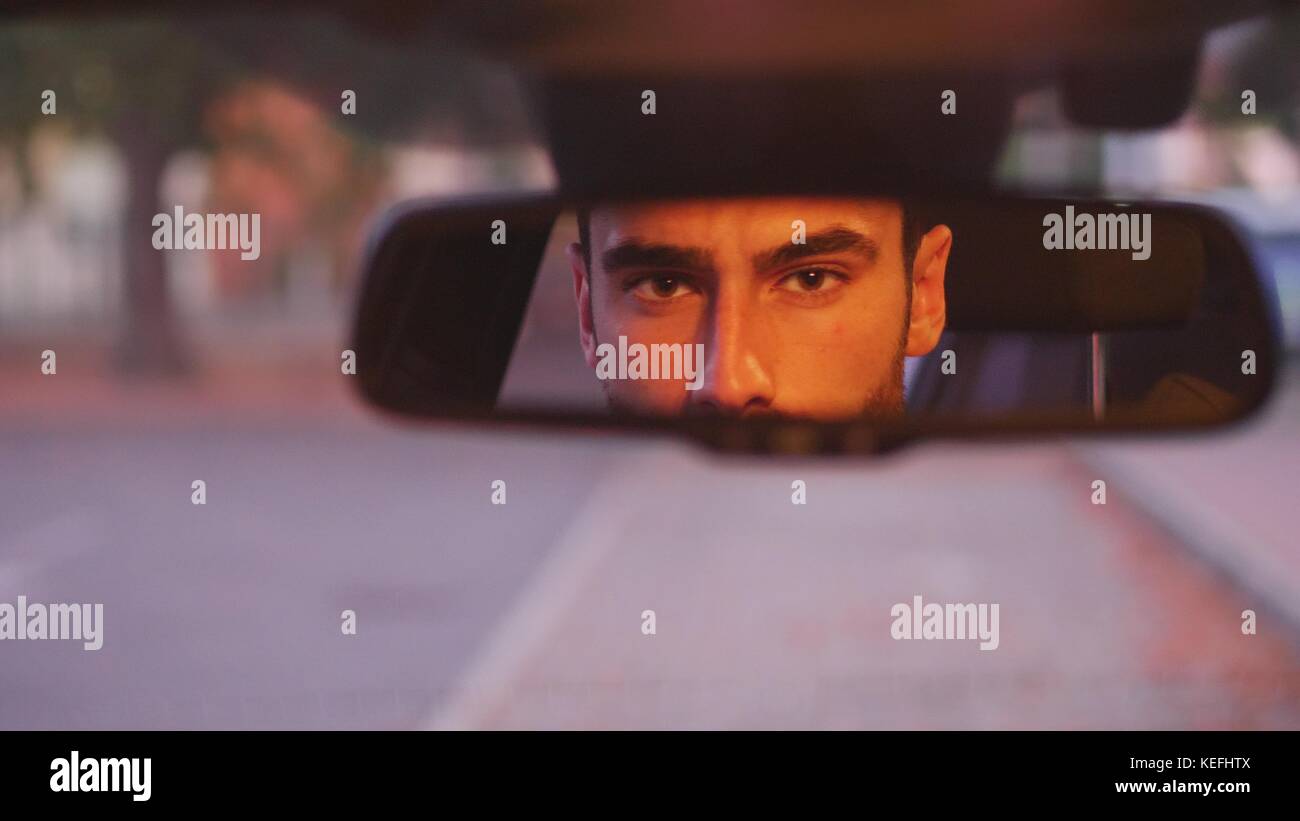 Man Looking In Rearview Mirror