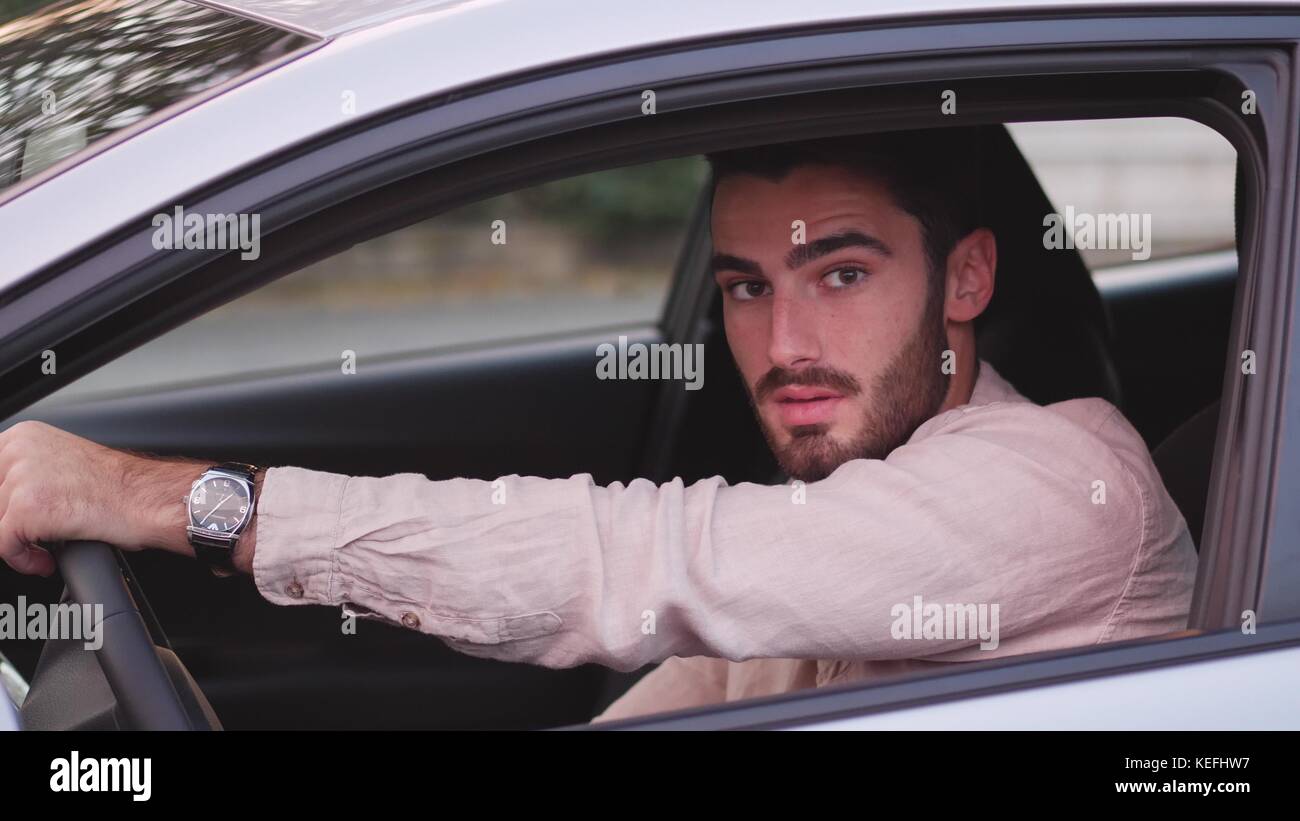 Serious young man teenager driving car looking at camera hi-res stock ... Serious young man teenager driving car looking at camera hi-res stock ...