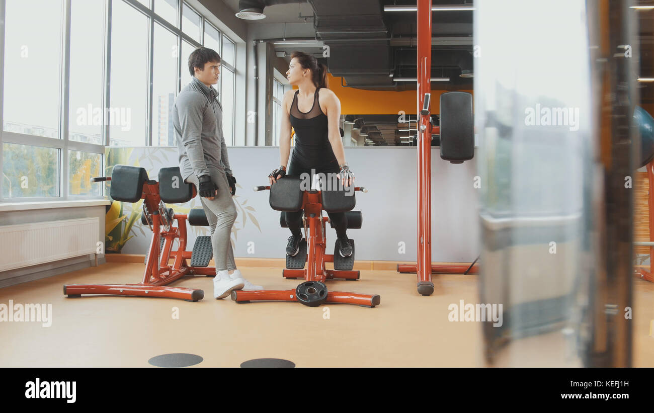 Athlete man and woman have conversation in the gym Stock Photo - Alamy
