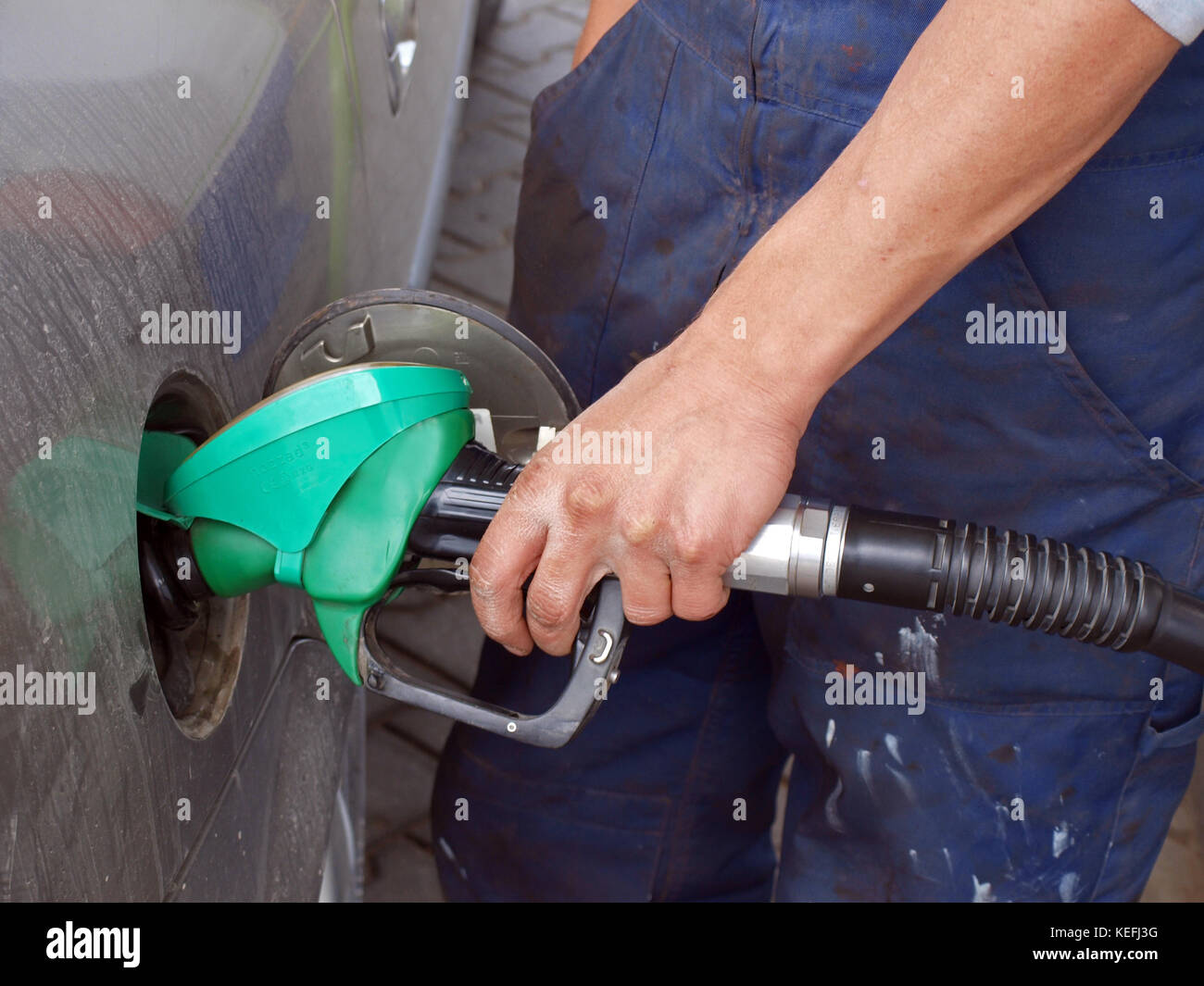 Man, filling the car tank with fuel Stock Photo - Alamy