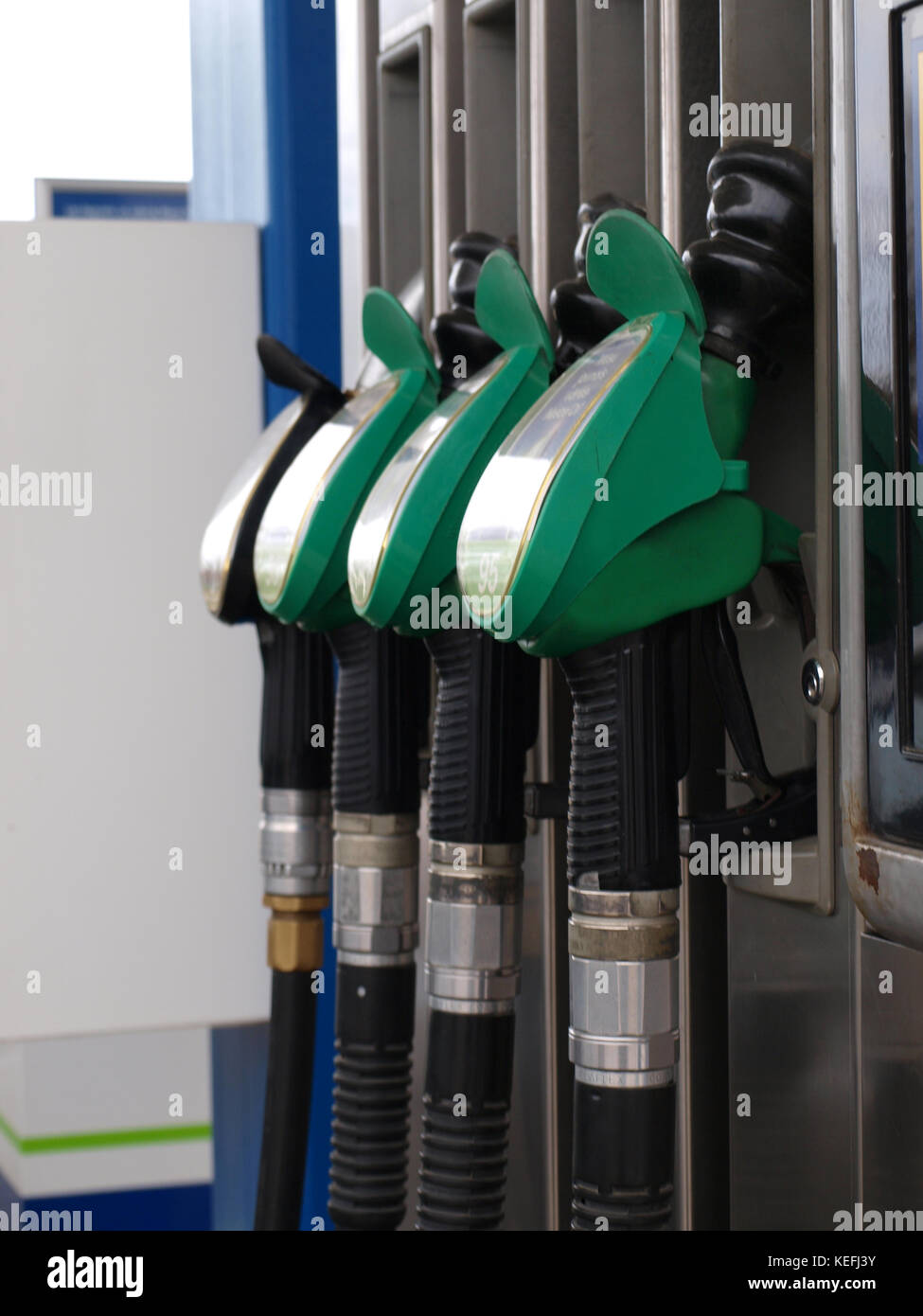 Fuel tanks pipes with handles on petrol station Stock Photo - Alamy