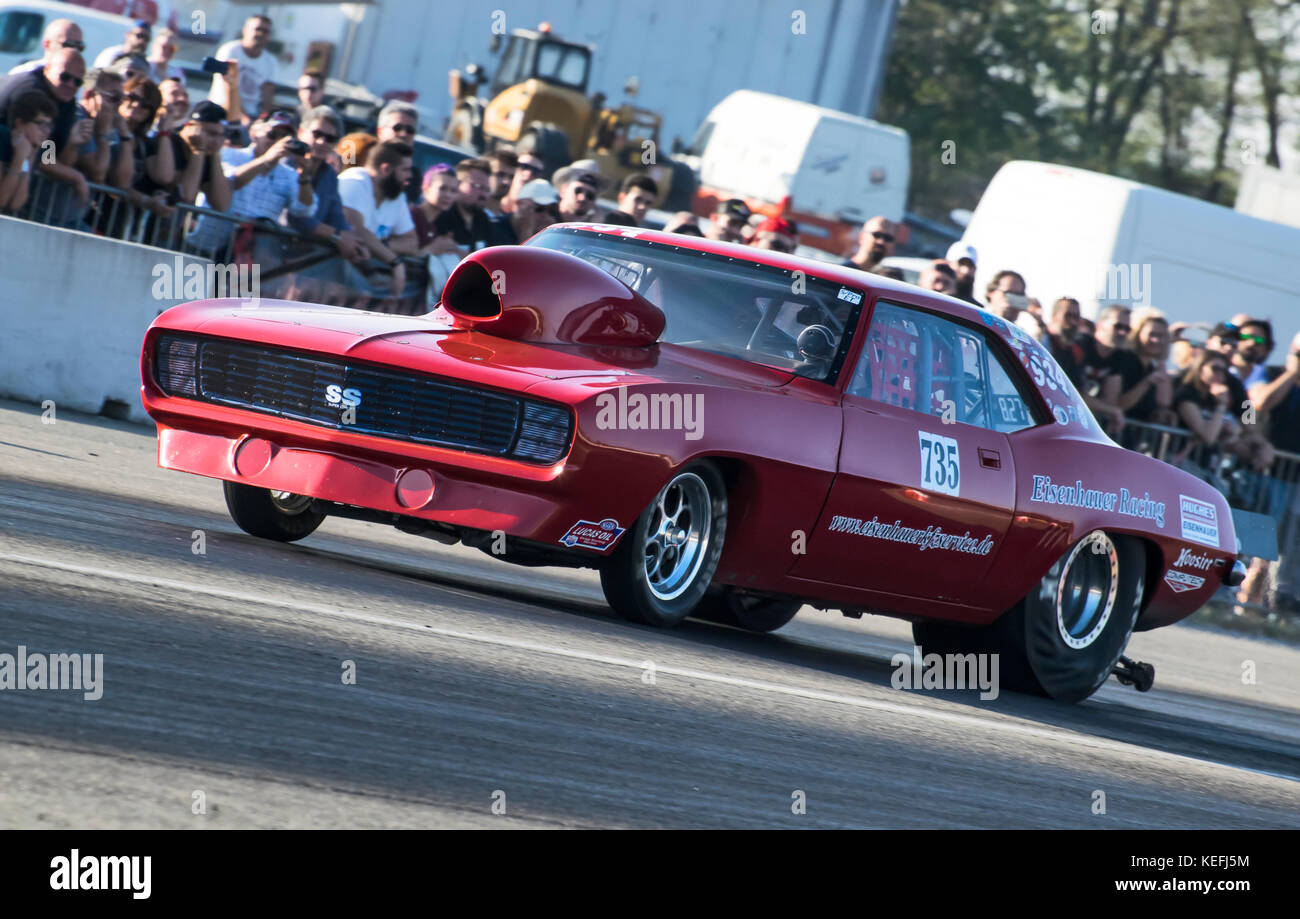 a classic chevy dragster car speeding on dragway during a motor show ...