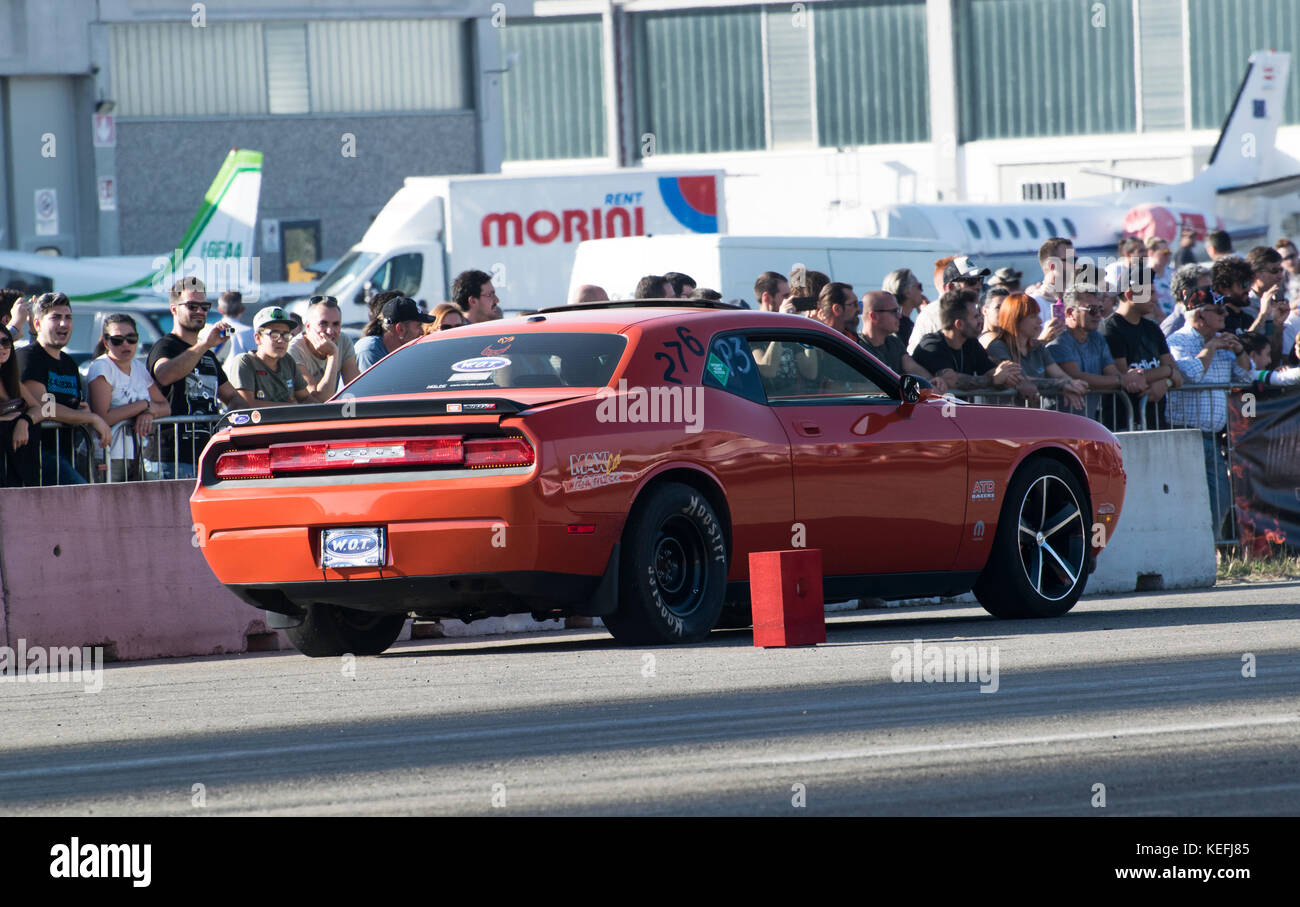 a classic mustang dragster car at a motor show competition speeding on ...