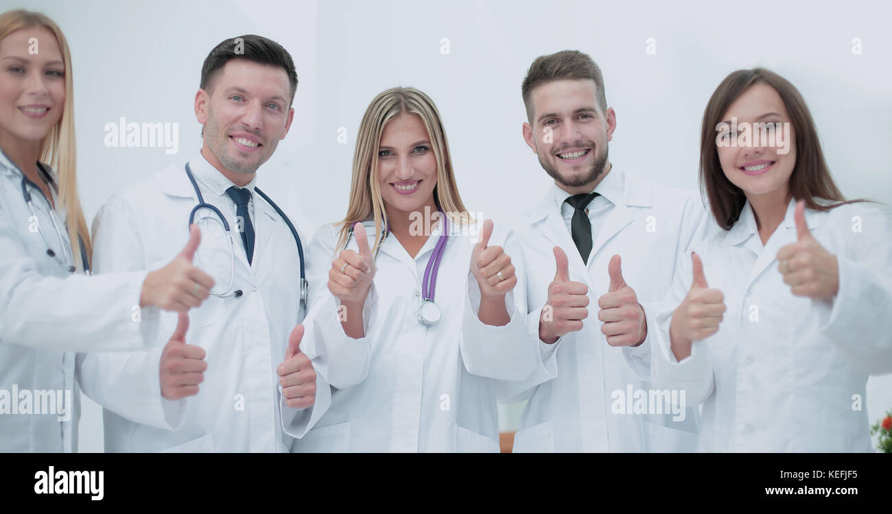 Happy doctors smiling and showing thumbs up Stock Photo - Alamy
