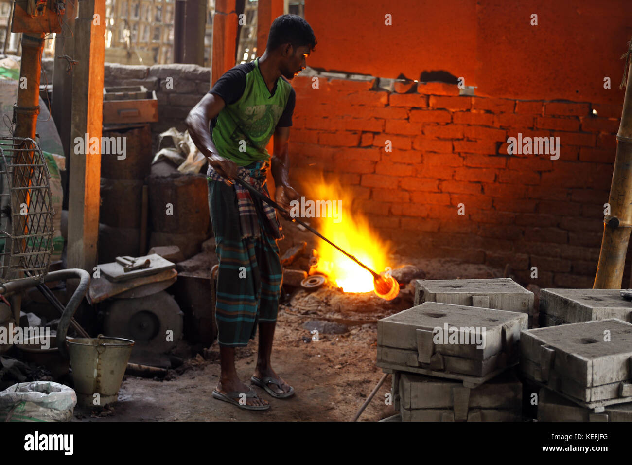 Workers in the steel re-rolling mills work without proper safety gear ...