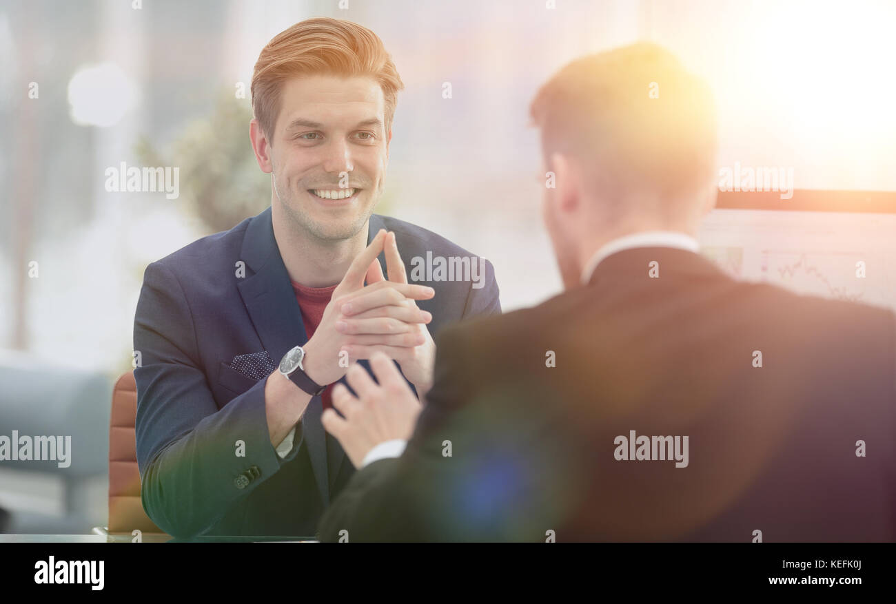 Business partners discussing in meeting hall Stock Photo - Alamy