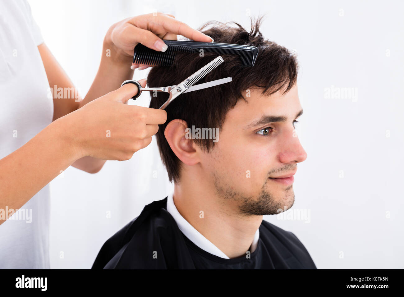 Happy Young Man Getting Haircut From Hairdresser Stock Photo - Alamy