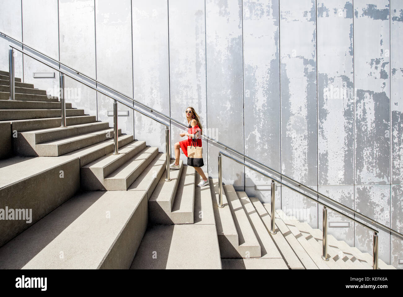 Woman walking up stairs success hi-res stock photography and images - Alamy