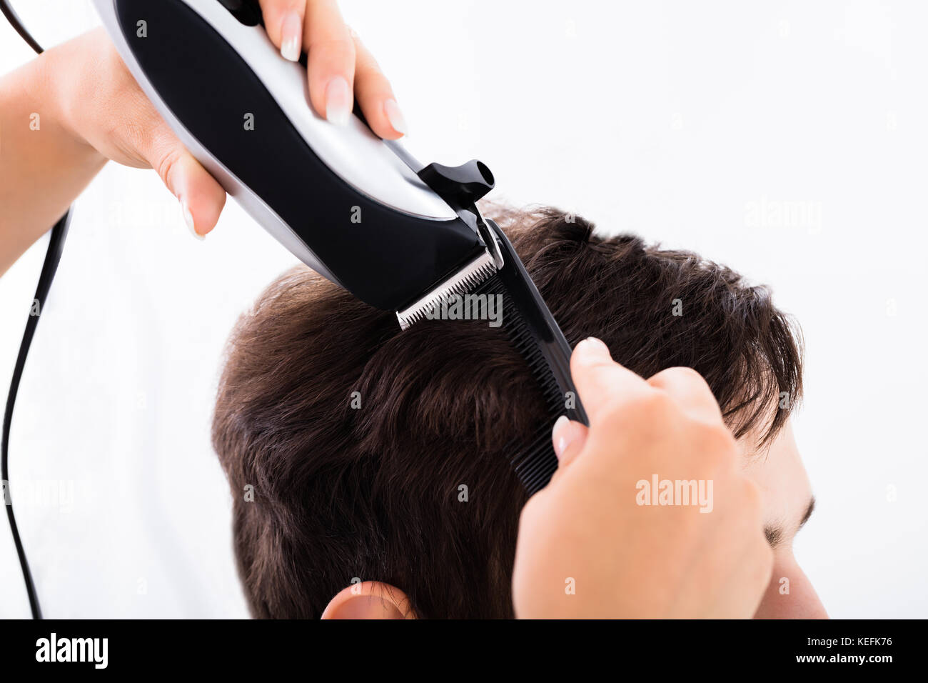 Hairdresser Cutting Person's Hair With Electric Trimmer Stock Photo - Alamy