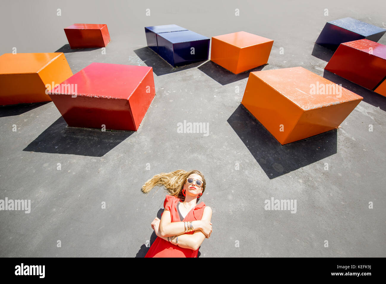Woman lying with colorful cubes Stock Photo - Alamy