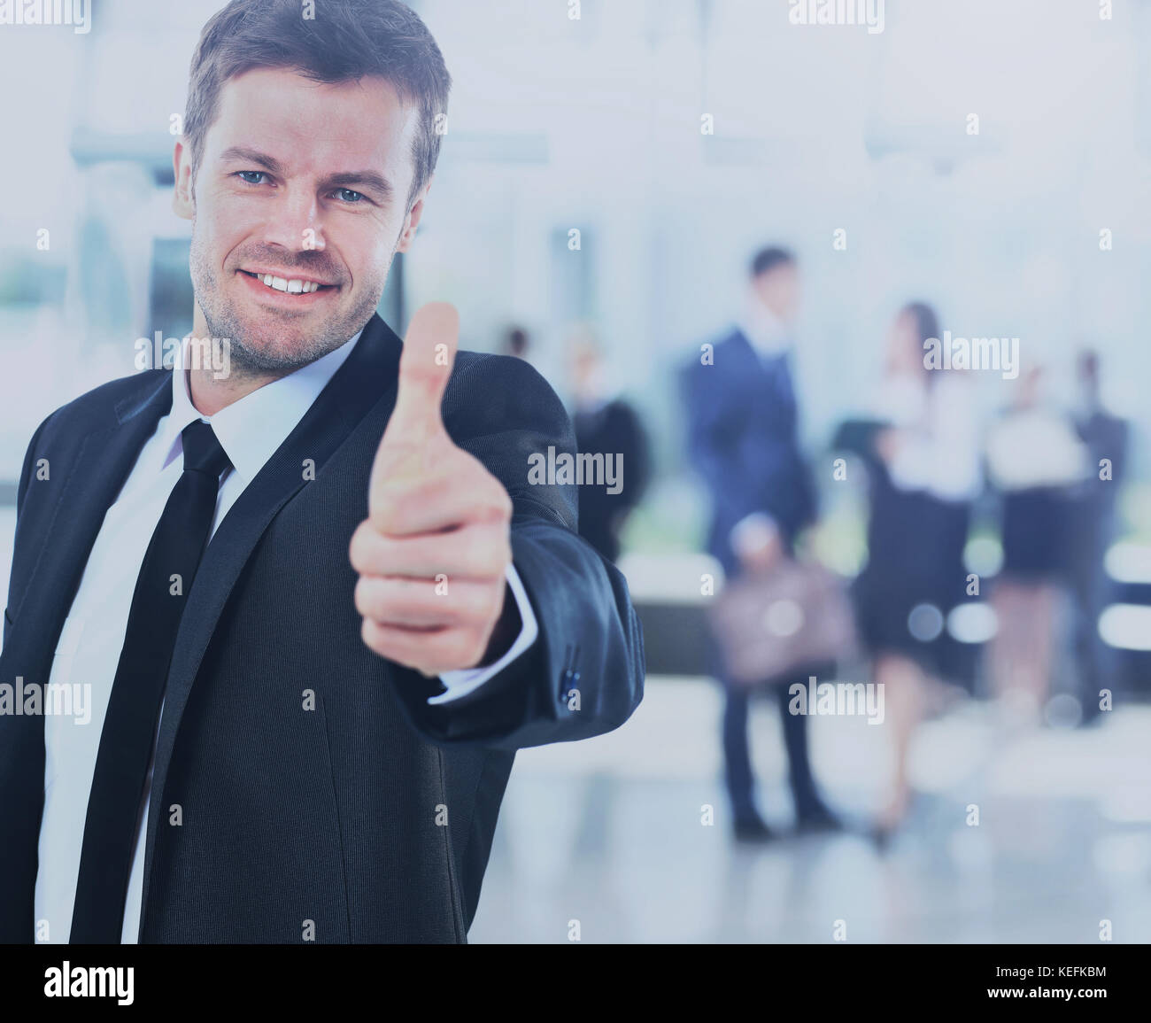 Businessman showing OK sign with his thumb up. Selective focus on face ...