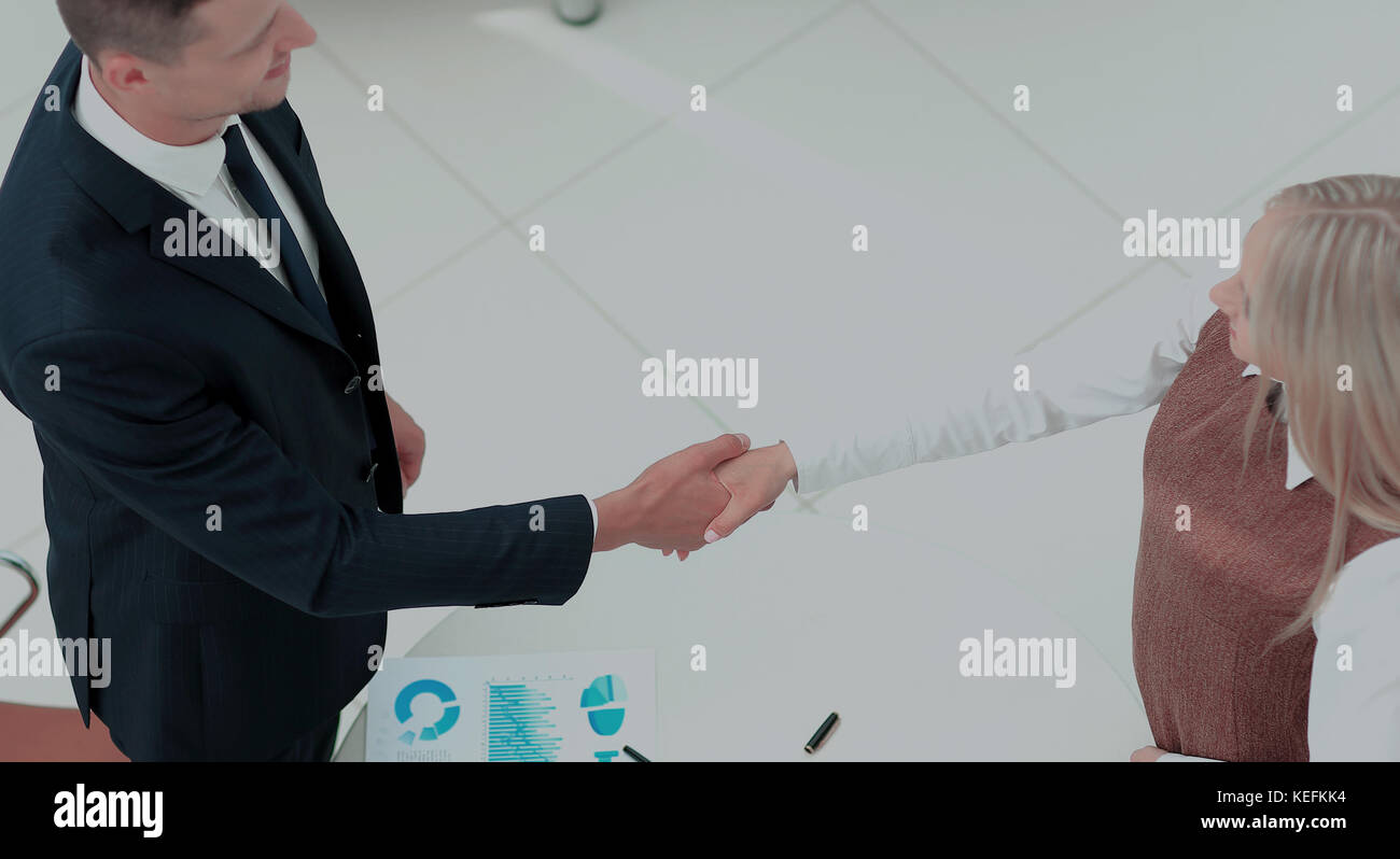 Business meeting at the table with handshake Stock Photo - Alamy